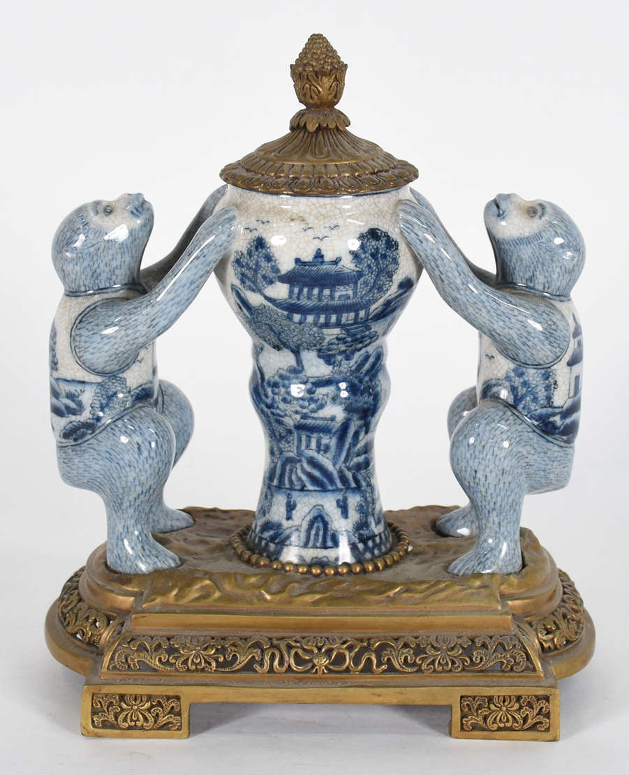 Grupo escultórico com vaso de porcelana ladeado... - Galeria Alphaville